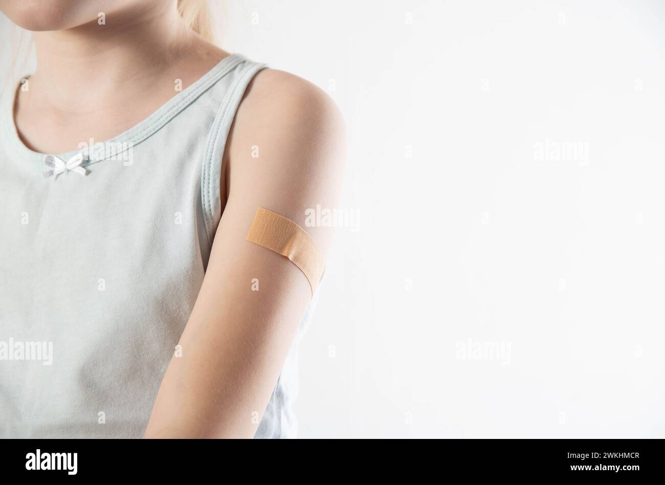 Plaster on the hand of a girl child after vaccination against influenza ...