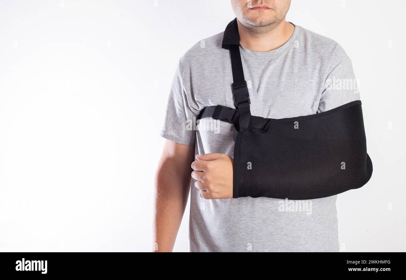 A man's arm in a black bandage for immobilization of the elbow joint ...