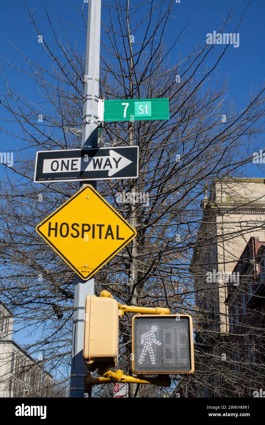 A one-way street sign with a pedestrian crossing sign in New York ...