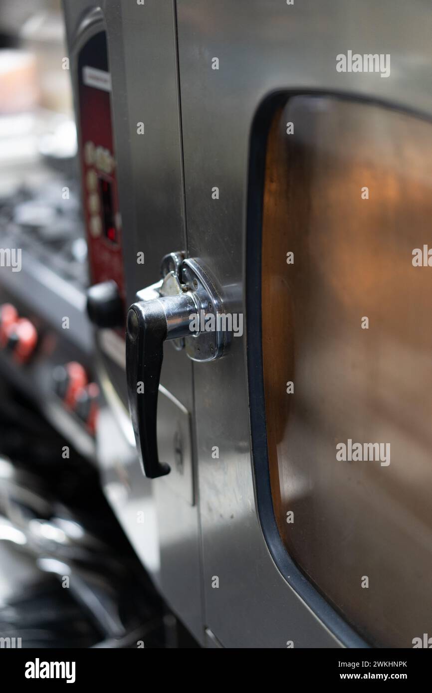 A close-up of a sleek handle on a professional kitchen oven Stock Photo ...