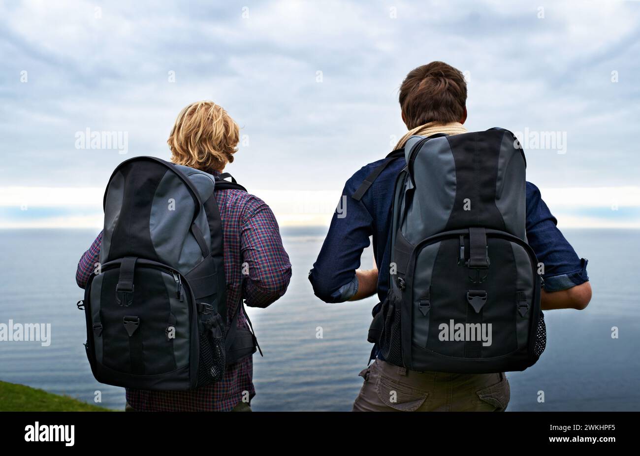 Couple, backpack and hiking by ocean for travel, sightseeing or outdoor ...