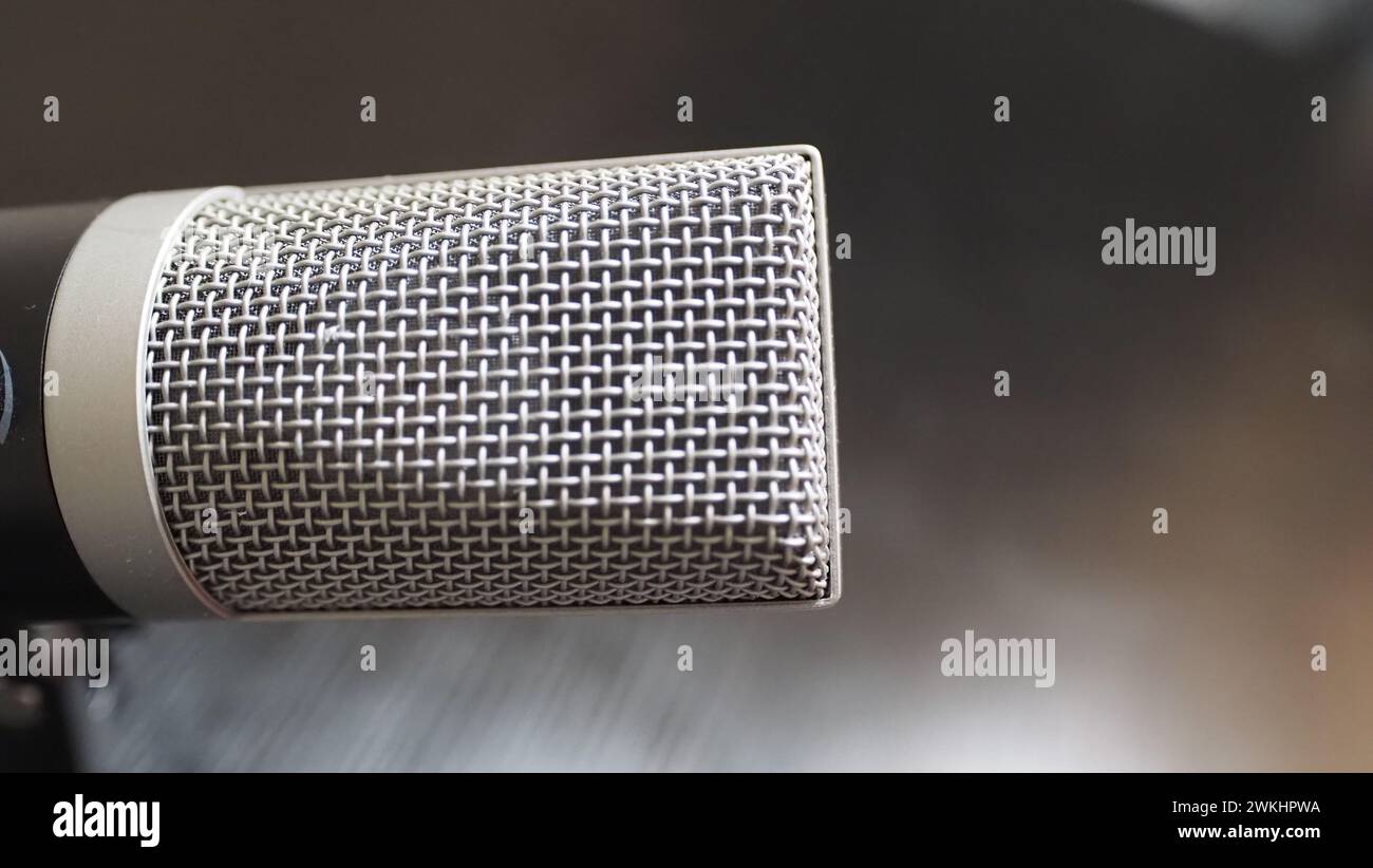 A silver microphone solid blurry background Stock Photo - Alamy