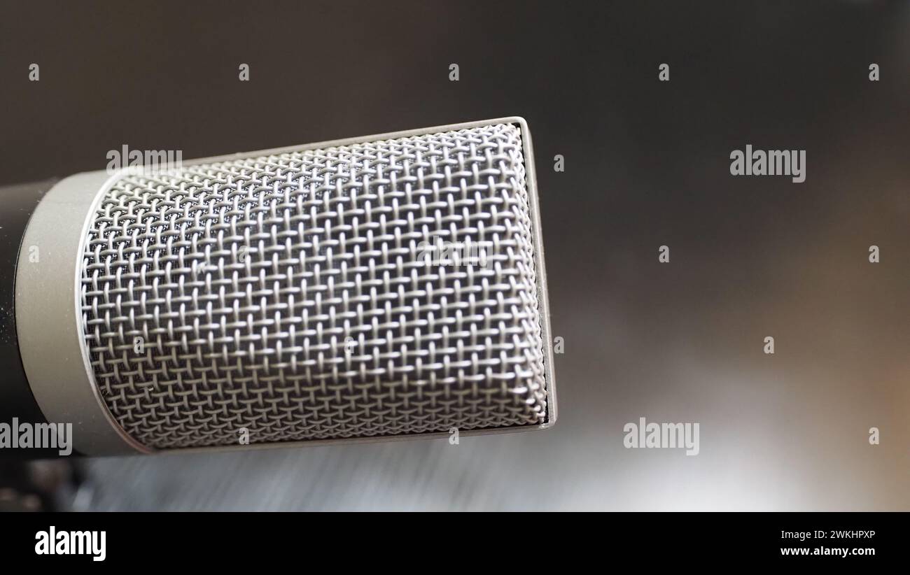 A silver microphone solid blurry background Stock Photo - Alamy