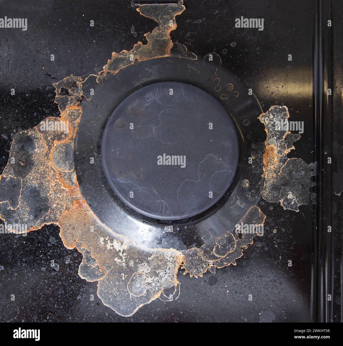 A gas stove burner dirty with scale and carbon deposits. Cleaning a gas ...