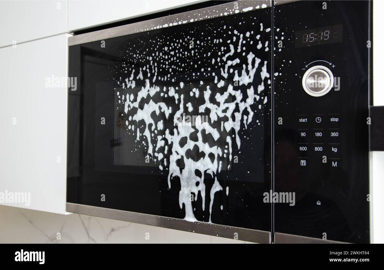 Foam on the microwave screen in the kitchen. The concept of cleaning ...