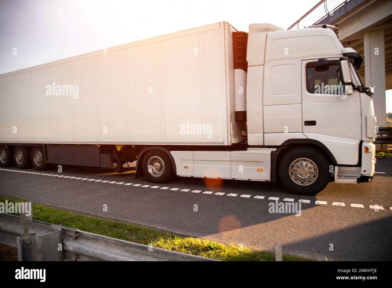 A white modern truck with an isothermal refrigerated semi-trailer ...