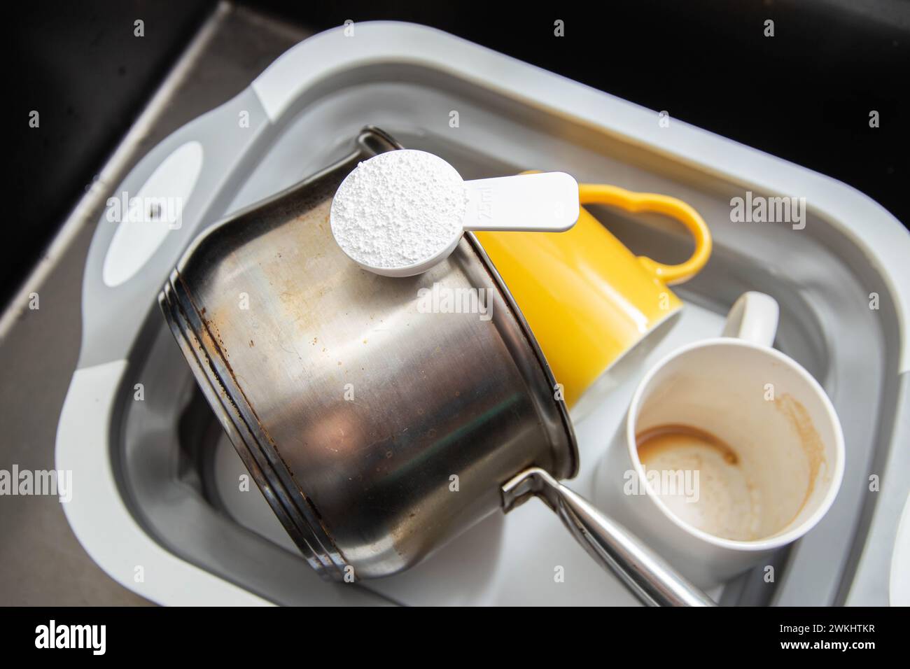 measuring spoon with granules of environmentally friendly oxygen bleach ...