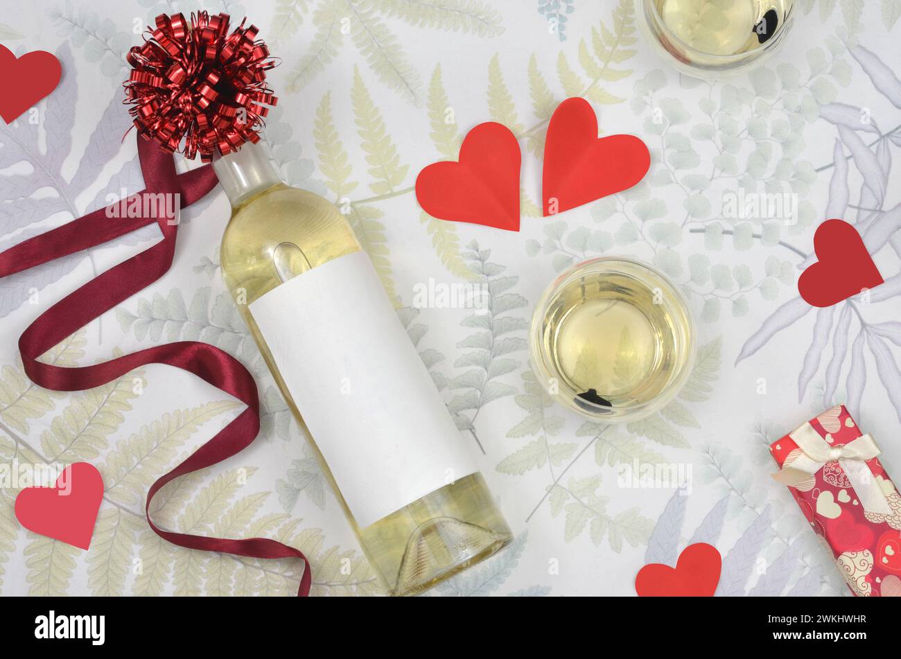 Bottle of wine with hearts and ribbon, blank space do fill on a bottle ...