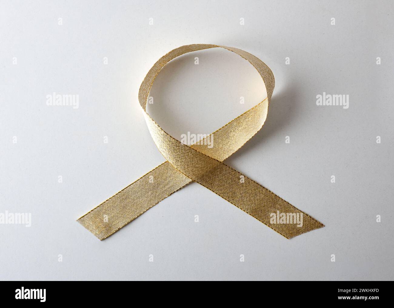 Shiny gold ribbon in corkscrew in upper right corner on white isolated ...