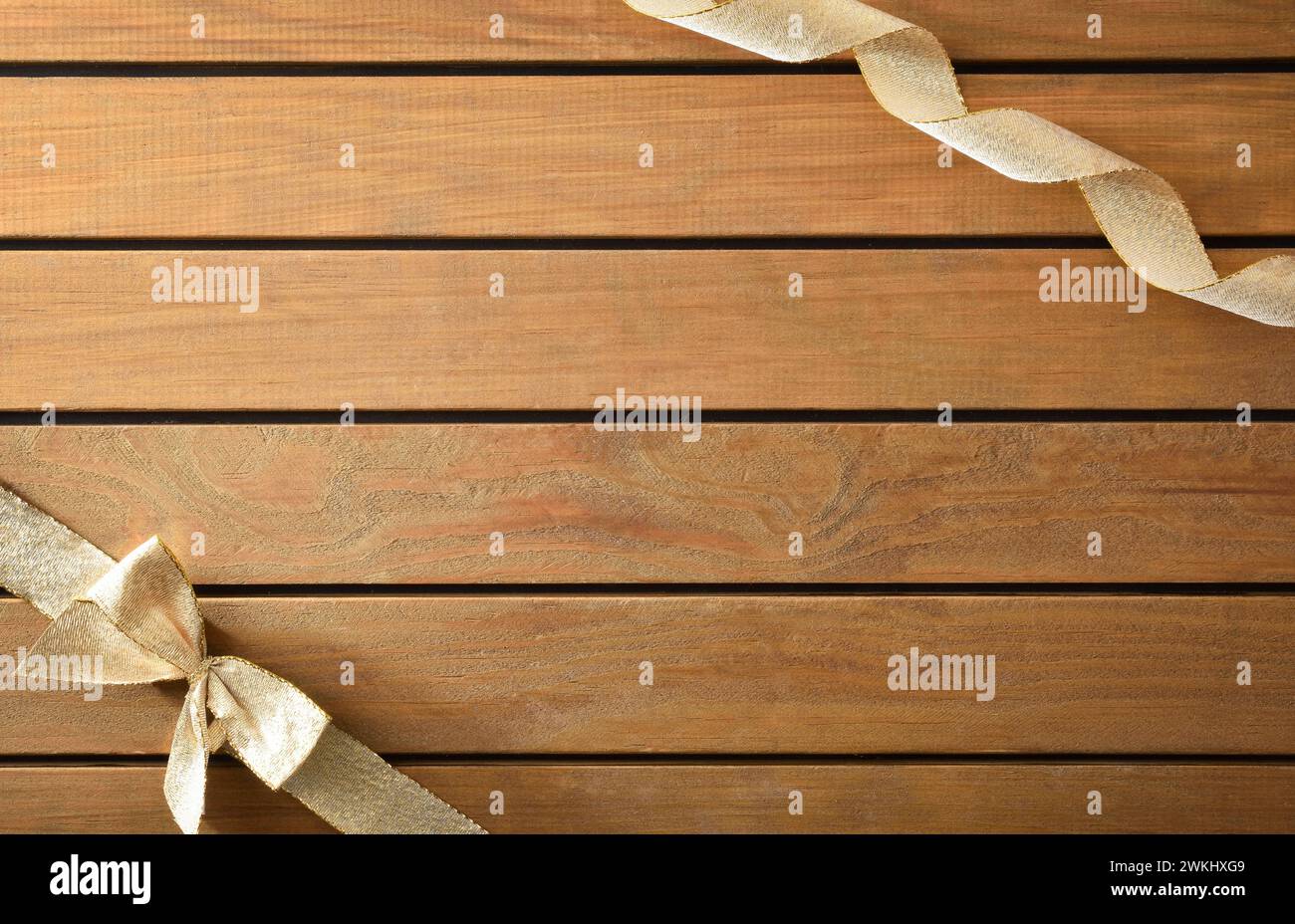 Background with shiny gold bow and wavy ribbon in the corners of a ...