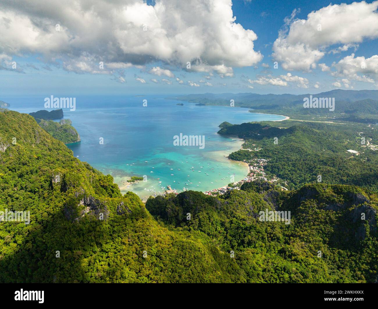 Boats on shoreline and town proper in El Nido, Philippines Stock Photo ...