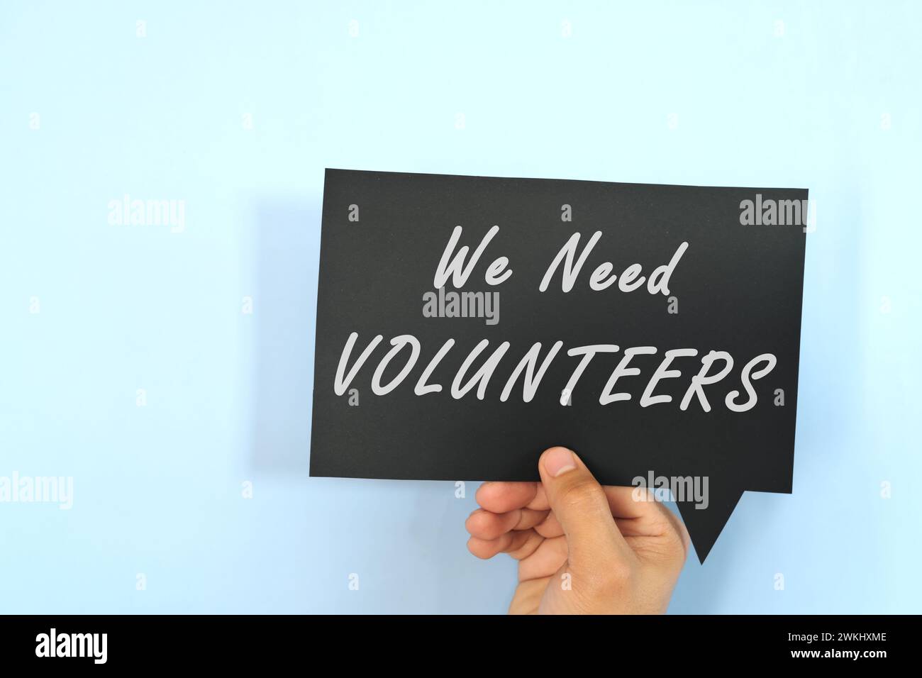 Human hand holding yellow speech bubble signage with written phrase ...