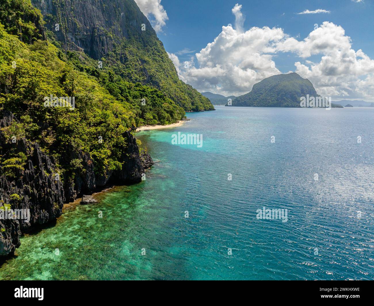 Limestone rock structure on Island with clear sea water and corals. El ...
