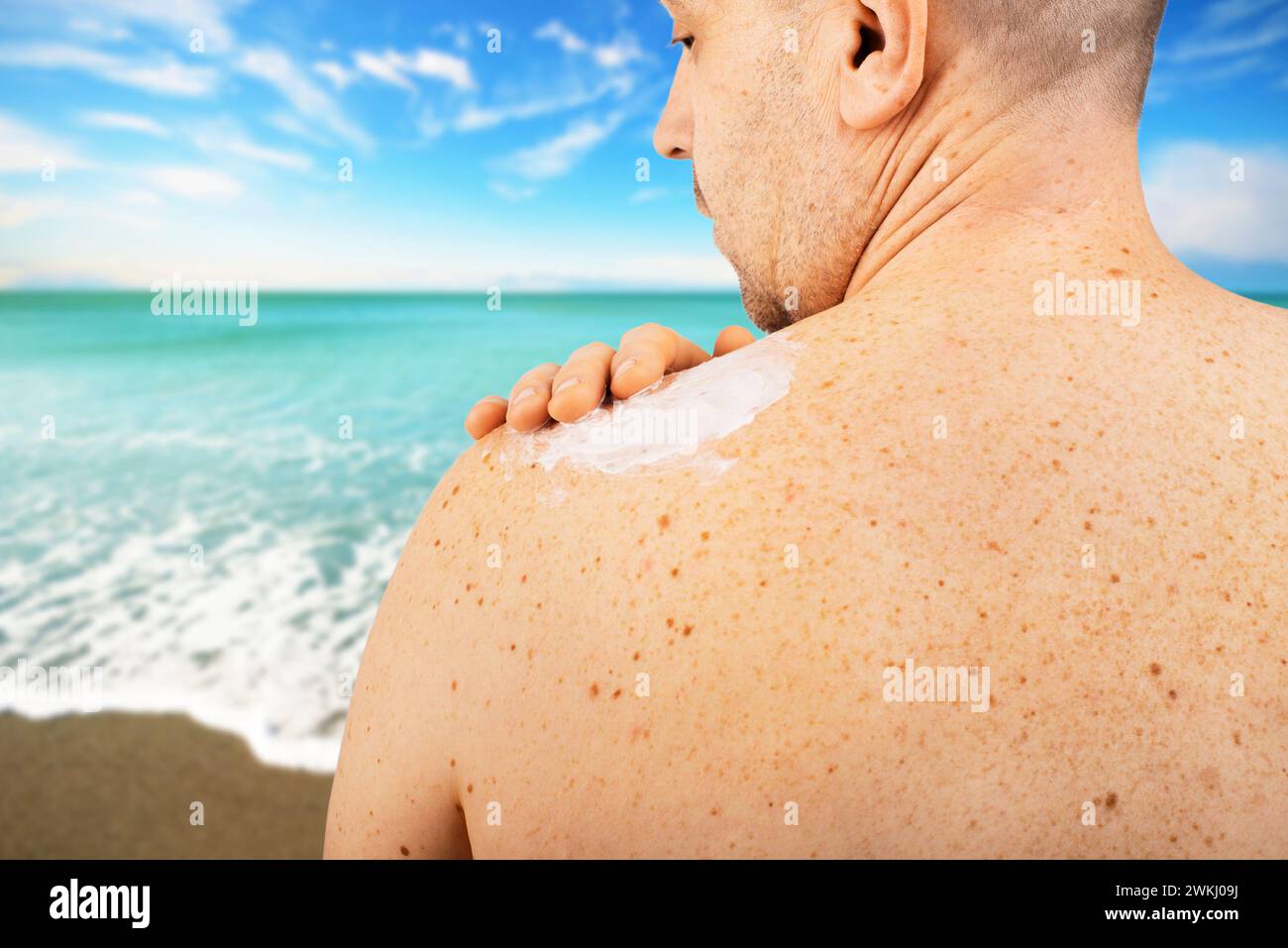 Middle aged caucasian male model applying sunscreen Stock Photo - Alamy
