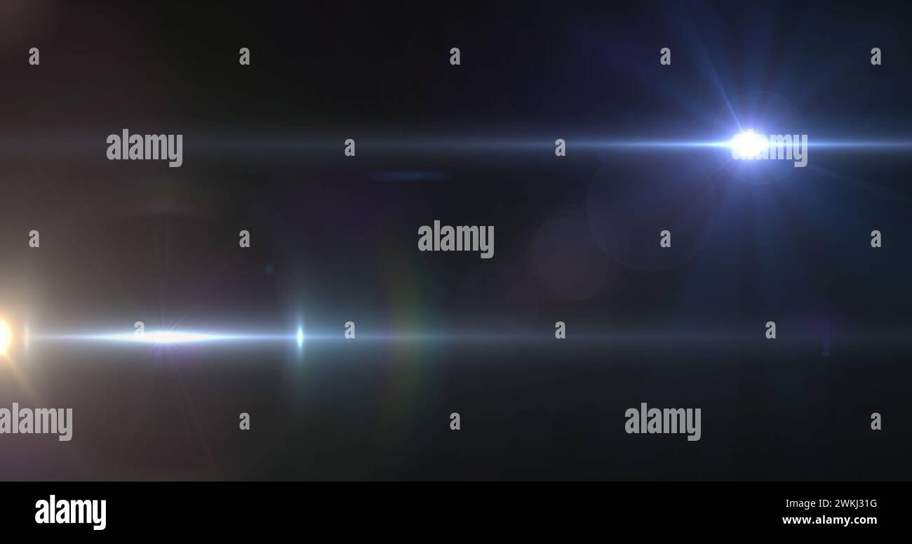 Image of spotlight with lens flare and light beams moving over dark ...
