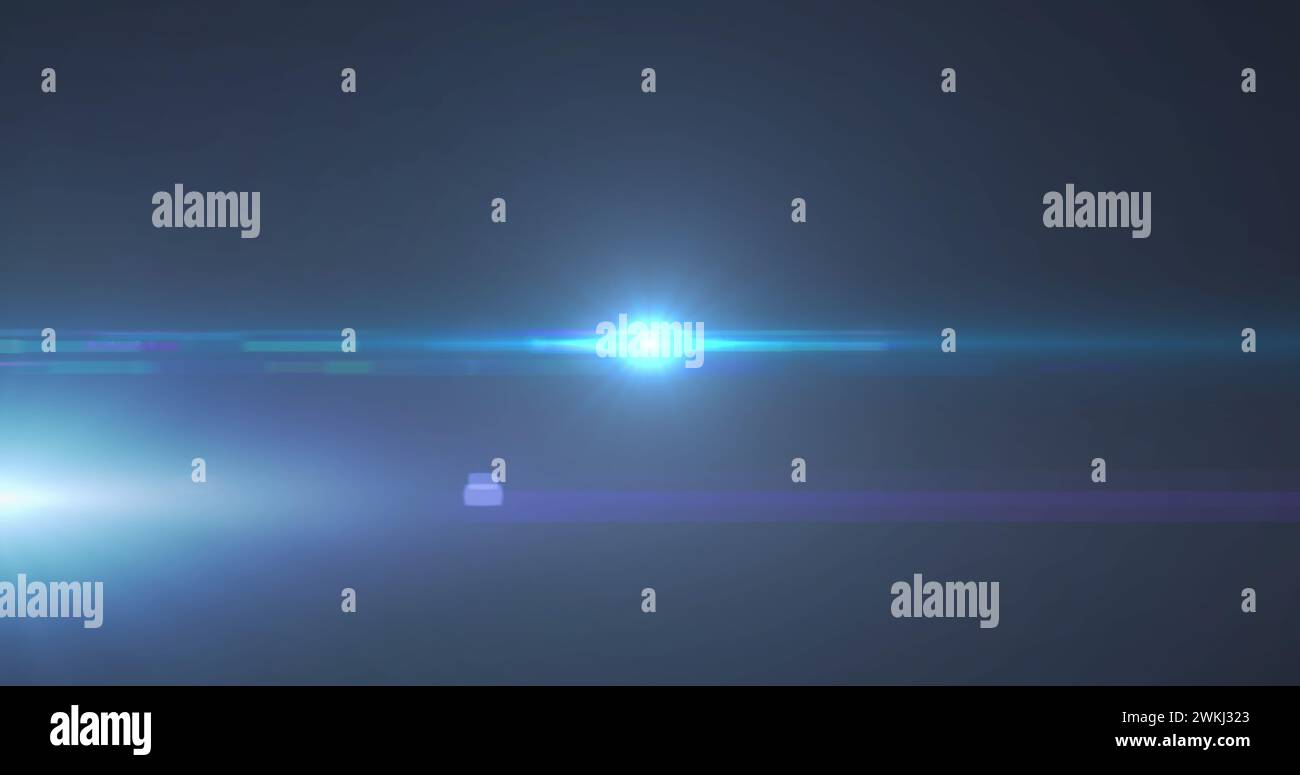 Image of blue spotlight with lens flare and light beams moving over ...