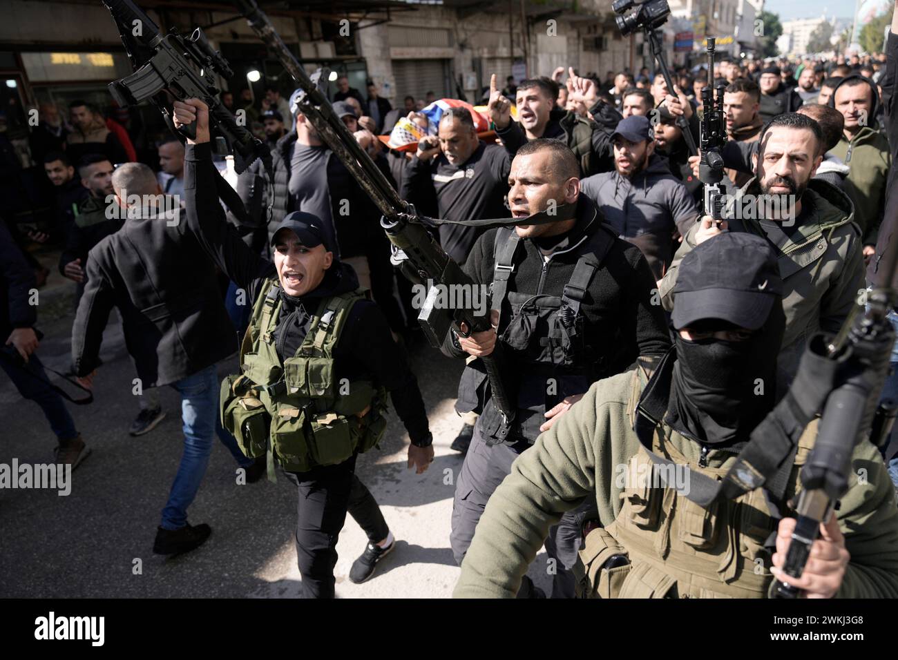 Gunmen march as mourners carry the body of Palestinian militant Aref ...
