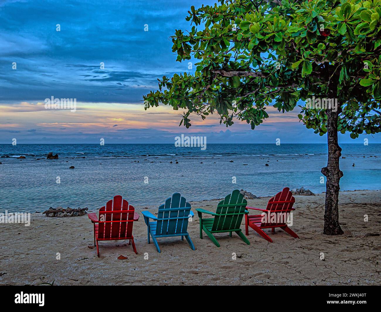 Four chairs on Roatan beach in summer Stock Photo - Alamy