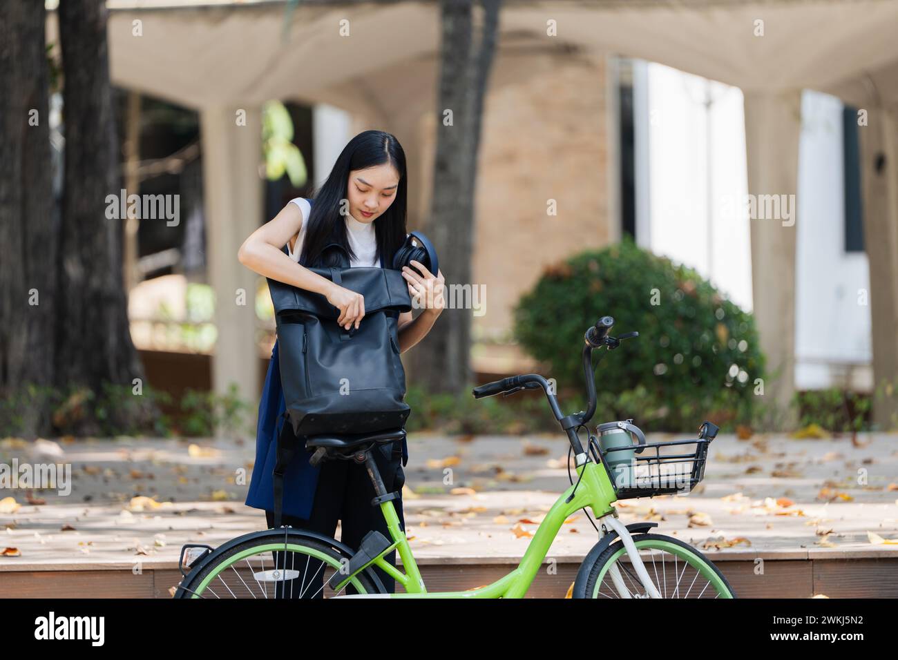 Asian young businesswoman bike to work for eco friendly green energy ...