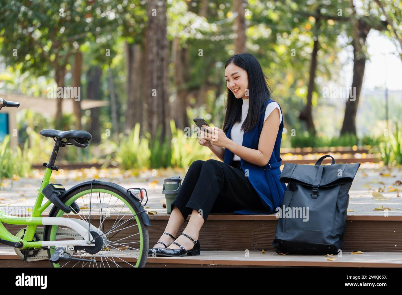 asian young businesswoman use smart phone while commuting in city. Eco ...
