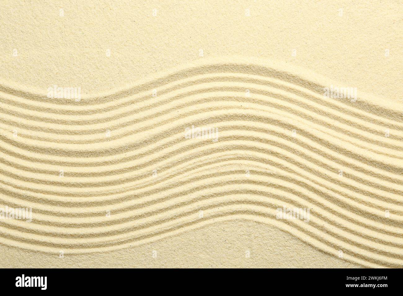 Zen rock garden. Wave pattern on beige sand, top view Stock Photo - Alamy