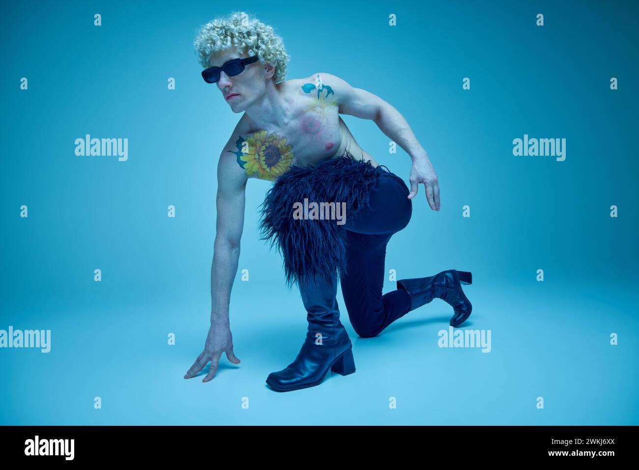 Portrait of male model in striking fashion-forward dance pose, mixing ...