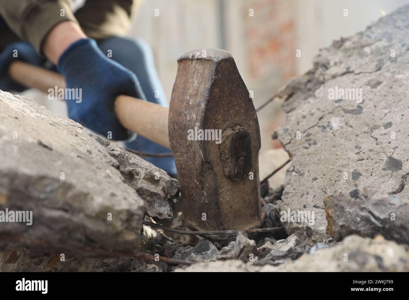 Man breaking stones with sledgehammer outdoors, closeup Stock Photo - Alamy