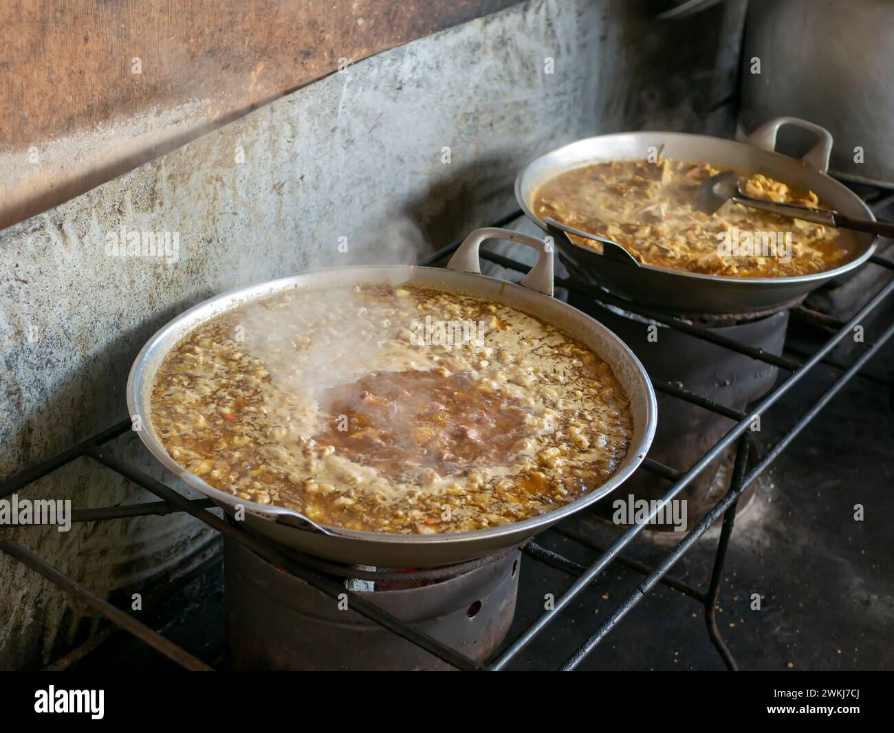 Cooking Tongseng Kambing, a spicy curry made from goat meat, in a large ...