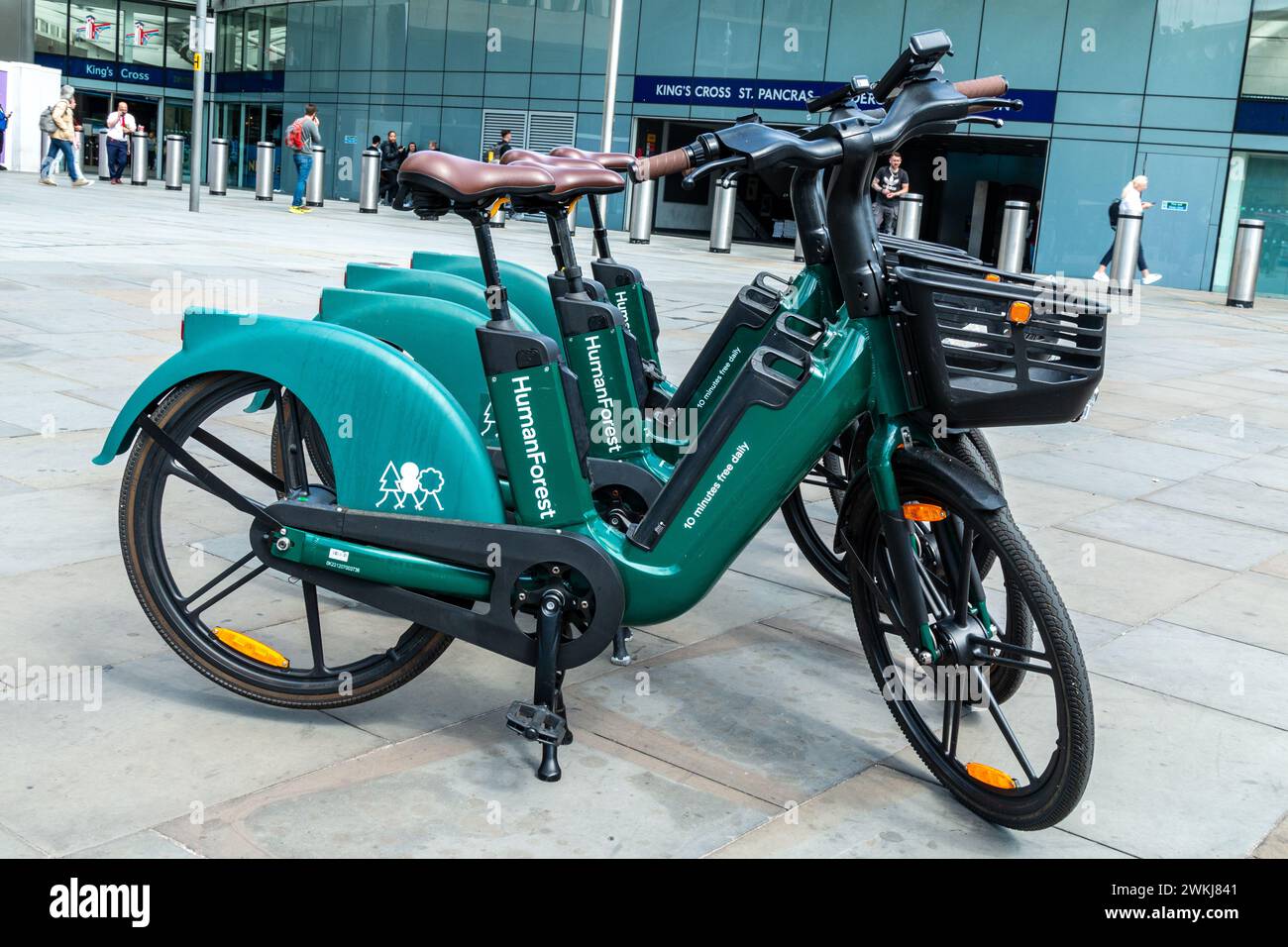 A row of Human Forest electric hire bicycles outside Kings Cross train ...