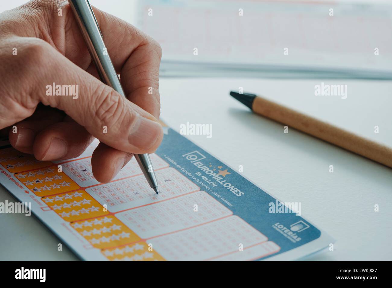 Barcelona, Spain - February 8, 2024: A man picks numbers from a ...