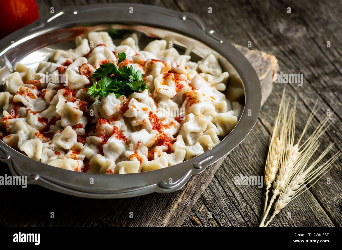 Turkish traditional food ravioli with yoghurt and tomato sauce in plate ...