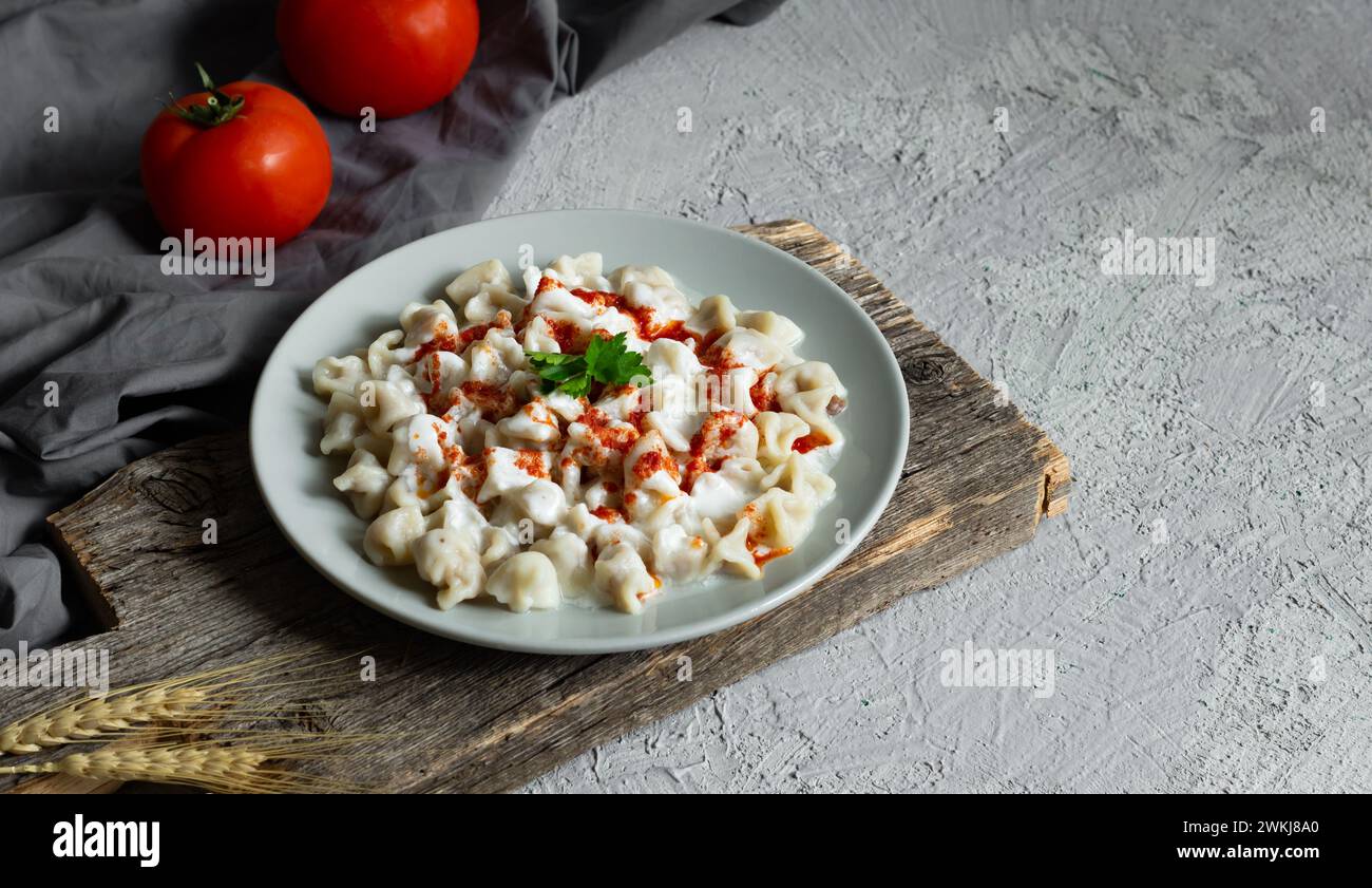 Turkish traditional food ravioli with yoghurt and tomato sauce in plate ...