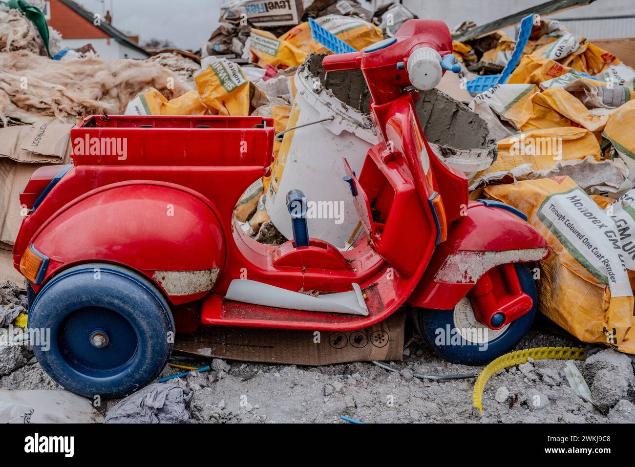 Child's tricycle, scooter, left in a trash, rubbish skip. Concept ...