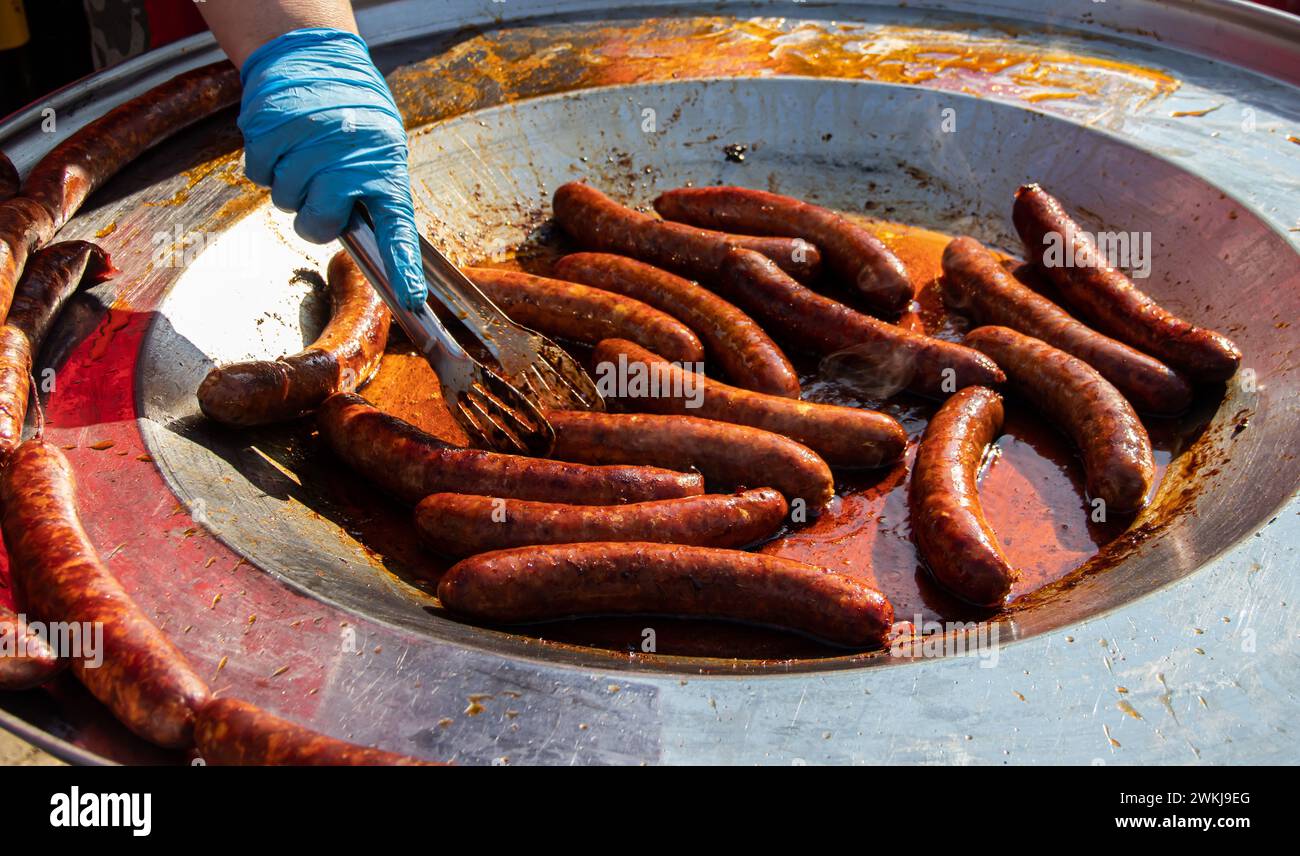 Street Food cooking on big frying pan, tasty home made sausages on ...