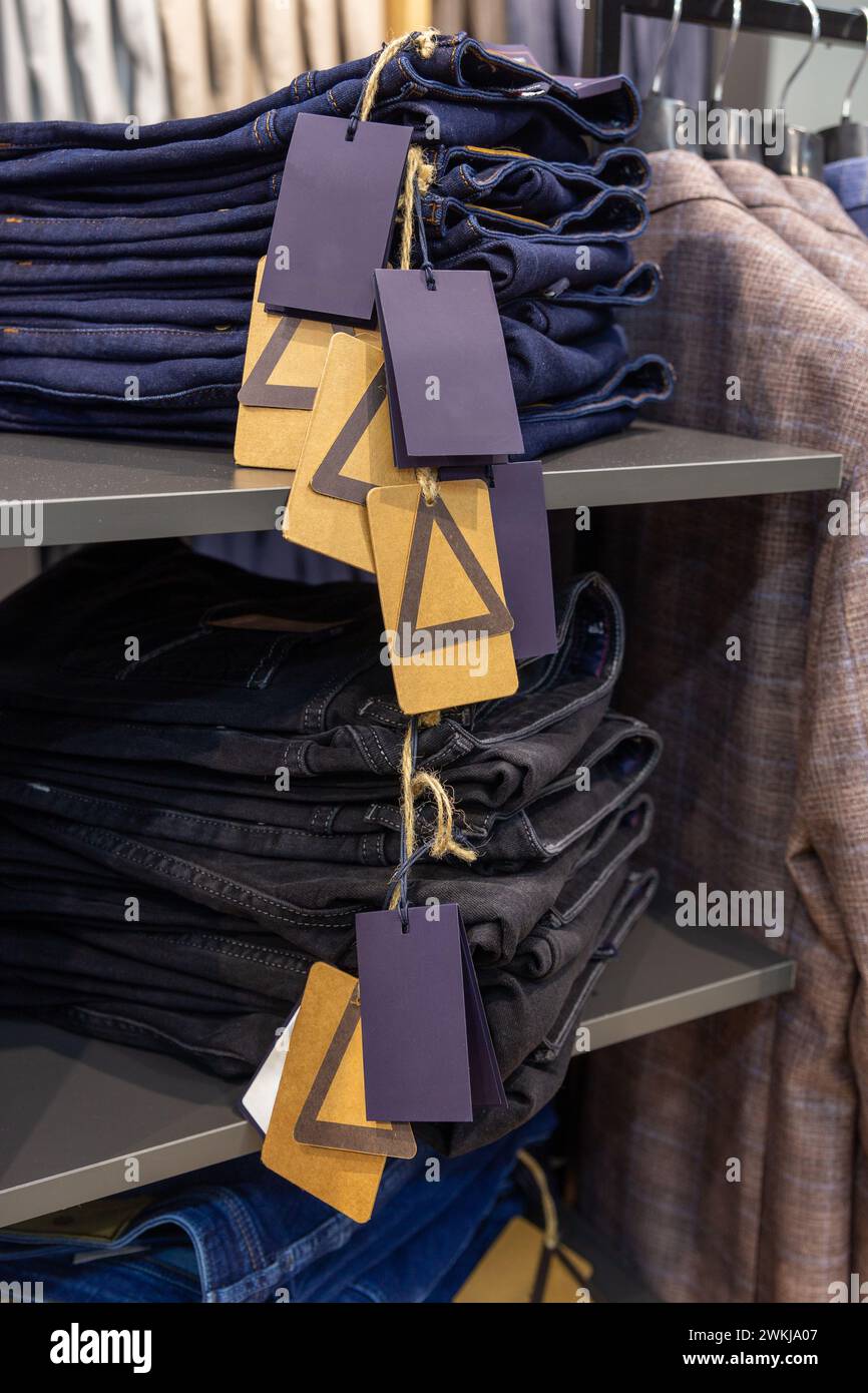 Close up denim jeans stacked in shop. Jeans a stack of folded pairs of ...