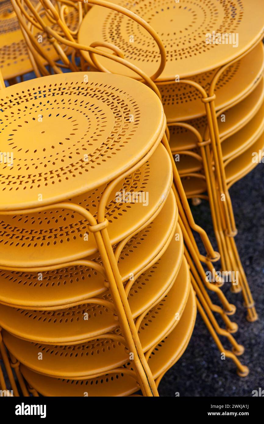 Stack of yellow metal chairs Stock Photo - Alamy
