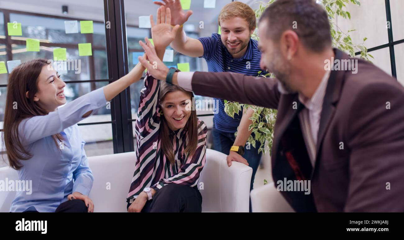 Business colleagues making high five gesture celebrating success. A ...