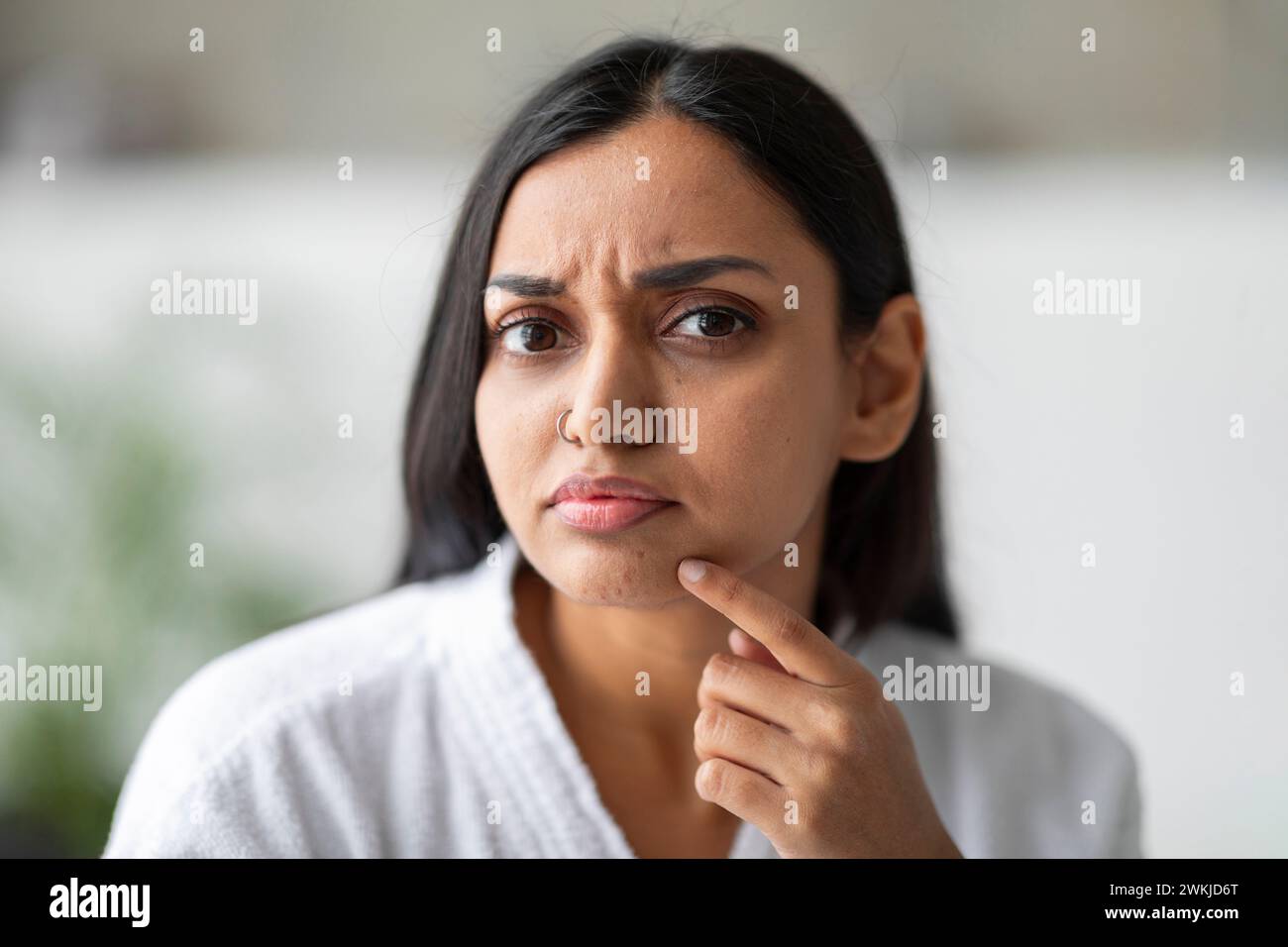 Closeup of upset young indian woman touching her face Stock Photo - Alamy