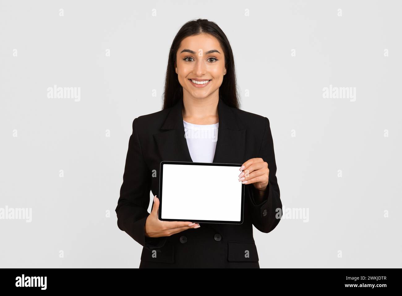 Professional woman presenting blank tablet screen Stock Photo - Alamy