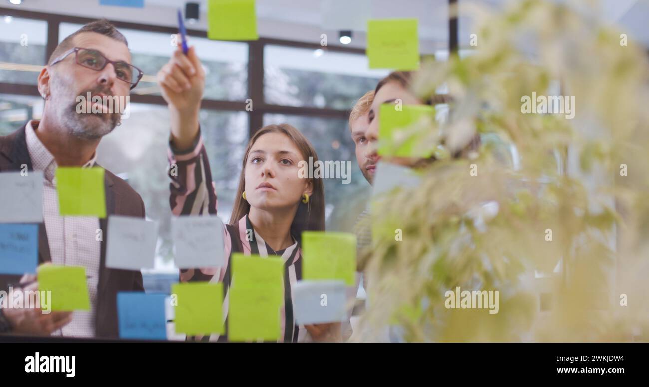 Team of caucasian business people standing near glass window with ...