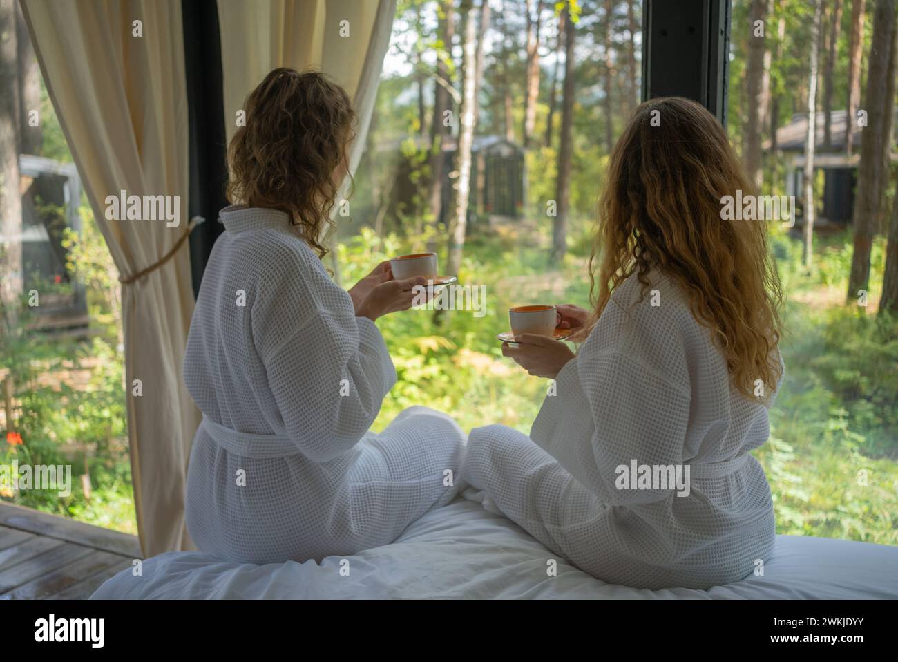 Two women in robes drinking hi-res stock photography and images - Alamy