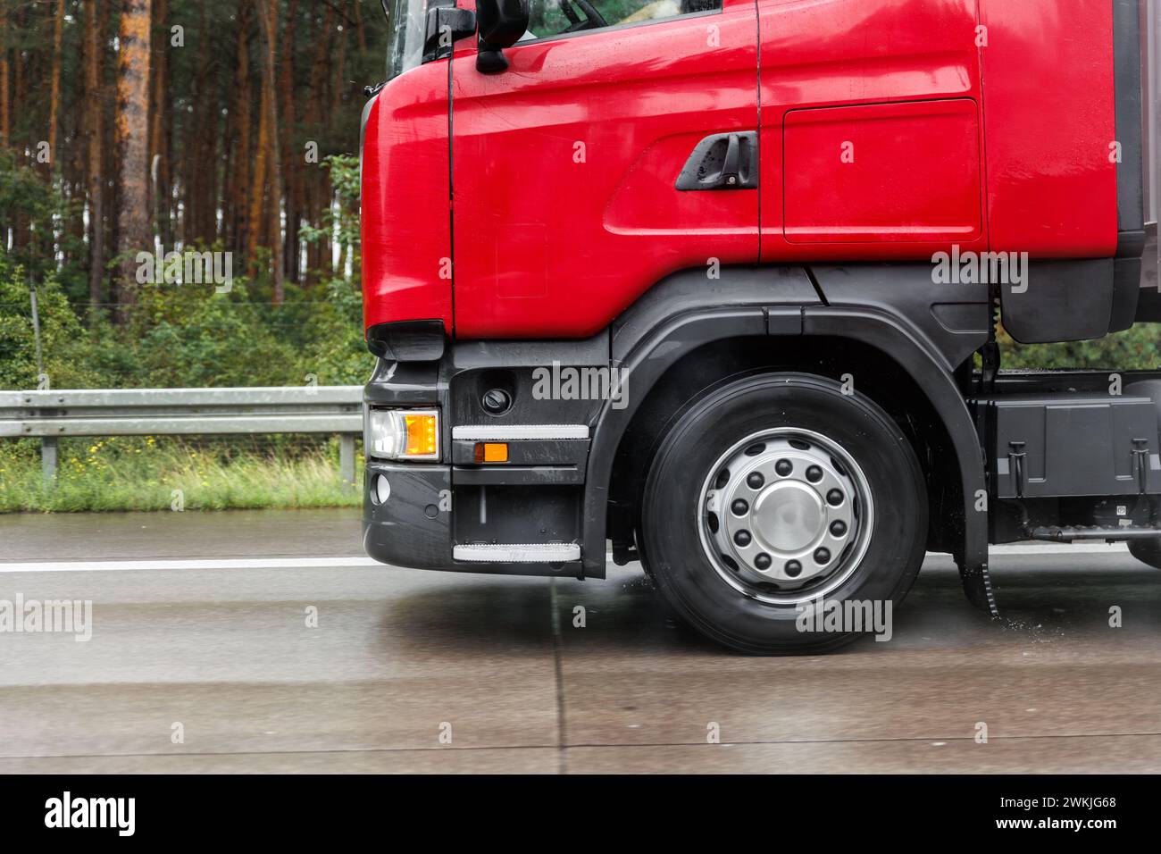 Close-up semi-trailer truck wheel driving fast Splashing Water on ...