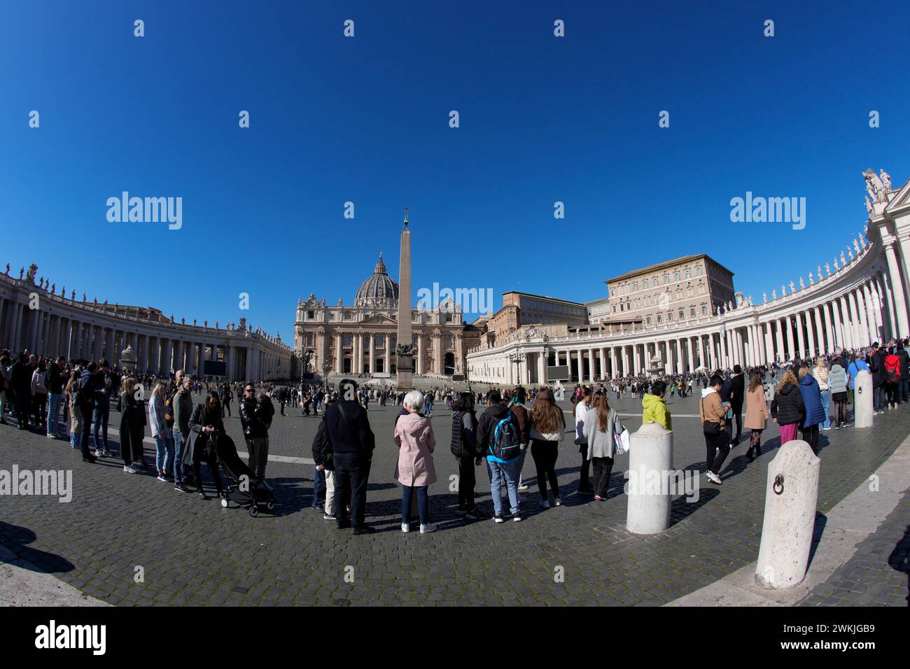 People stand in a line to enter St. Peter's Basilica at the Vatican ...
