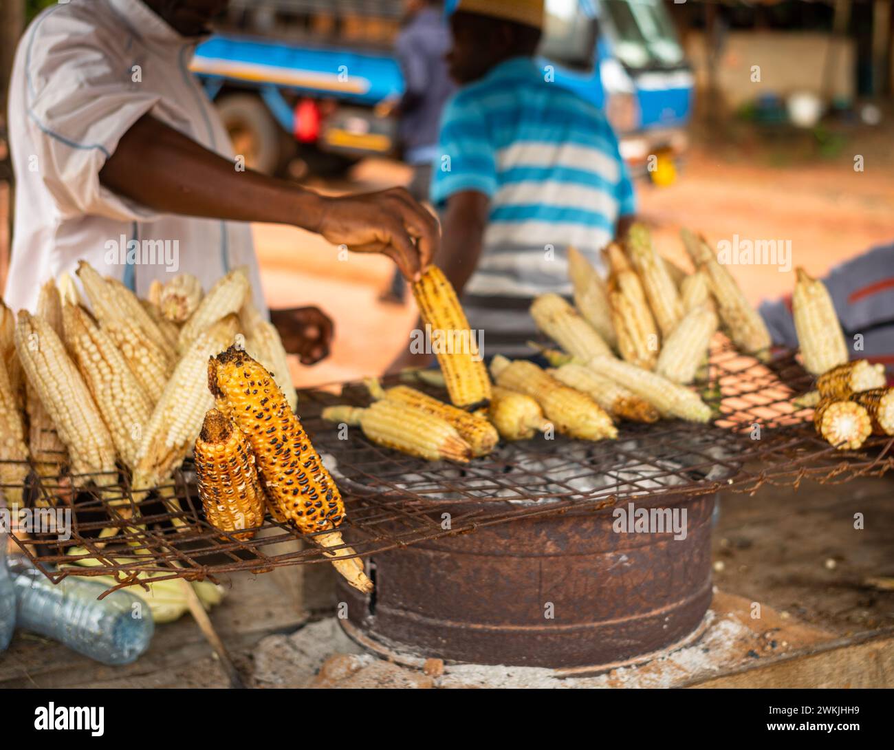 Man grills sweet corn at the market in Msanga in rural Tanzania Stock ...