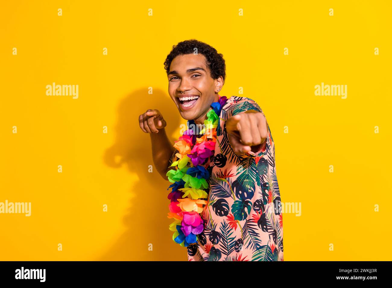 Photo of young cool guy in hawaiian necklace accessory dancing pointing ...
