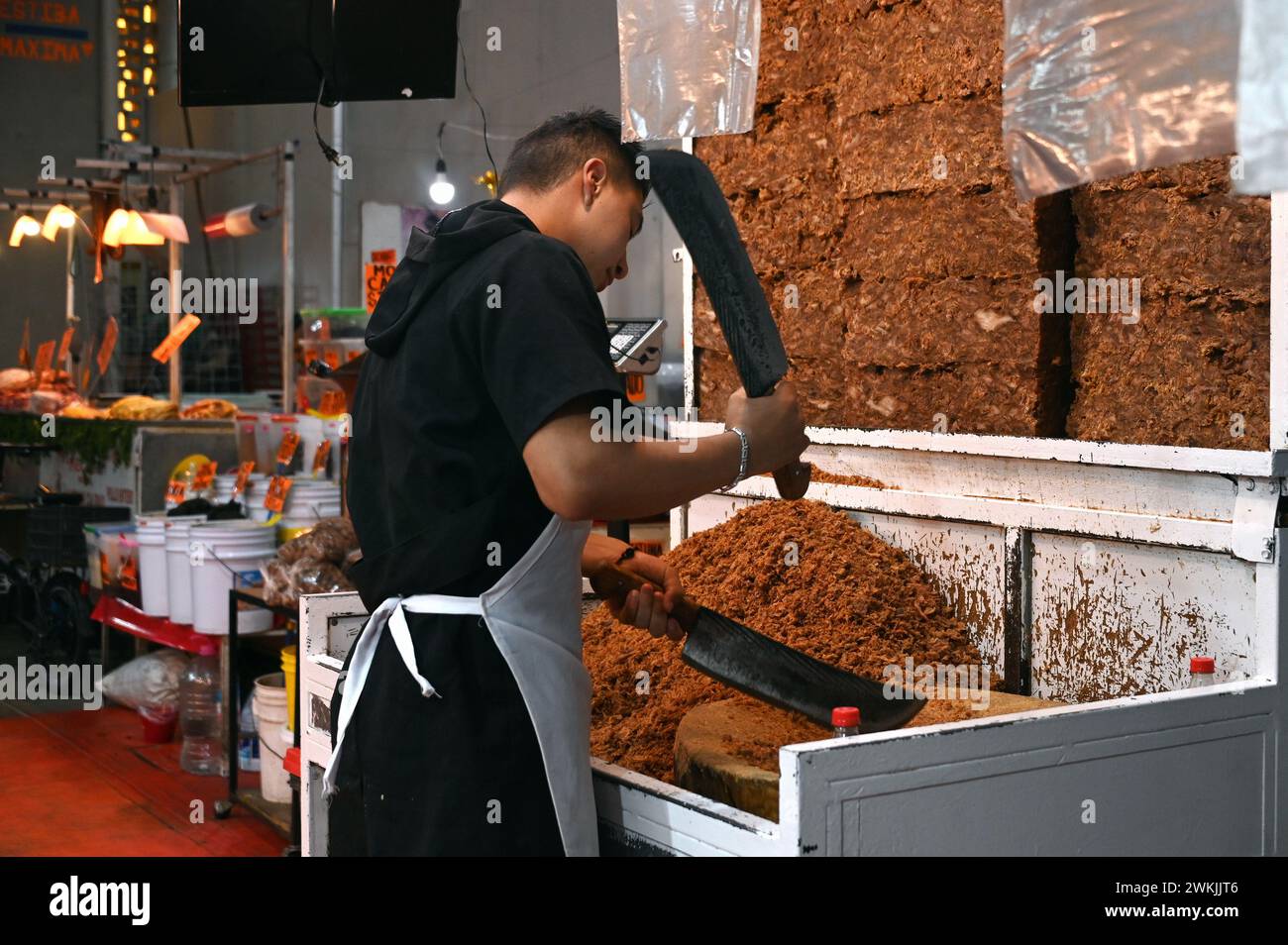 Butcher chopping meat with large knives in a market in the historic ...