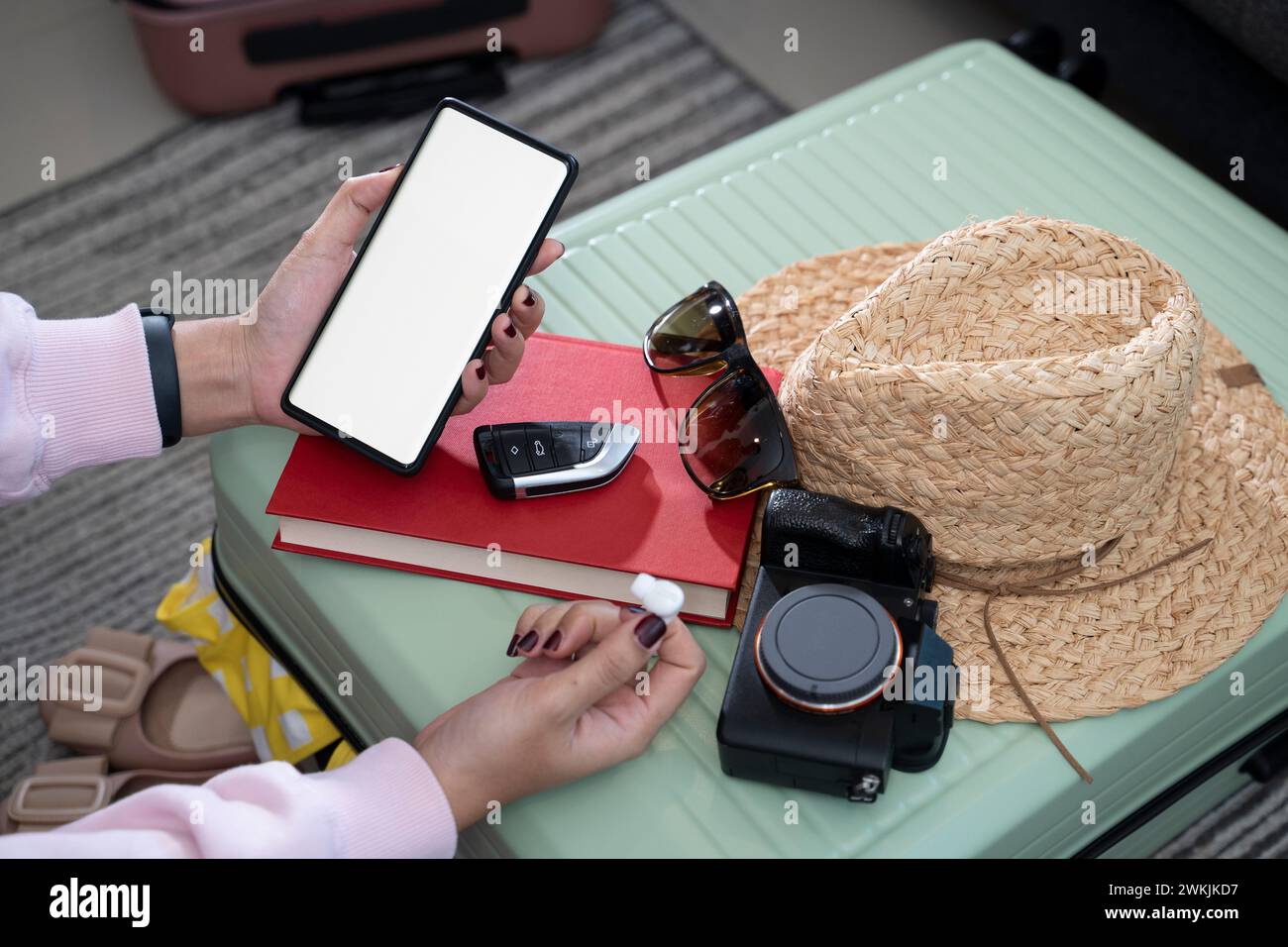 Packing for a trip and showing smart phone with blank screen Stock ...