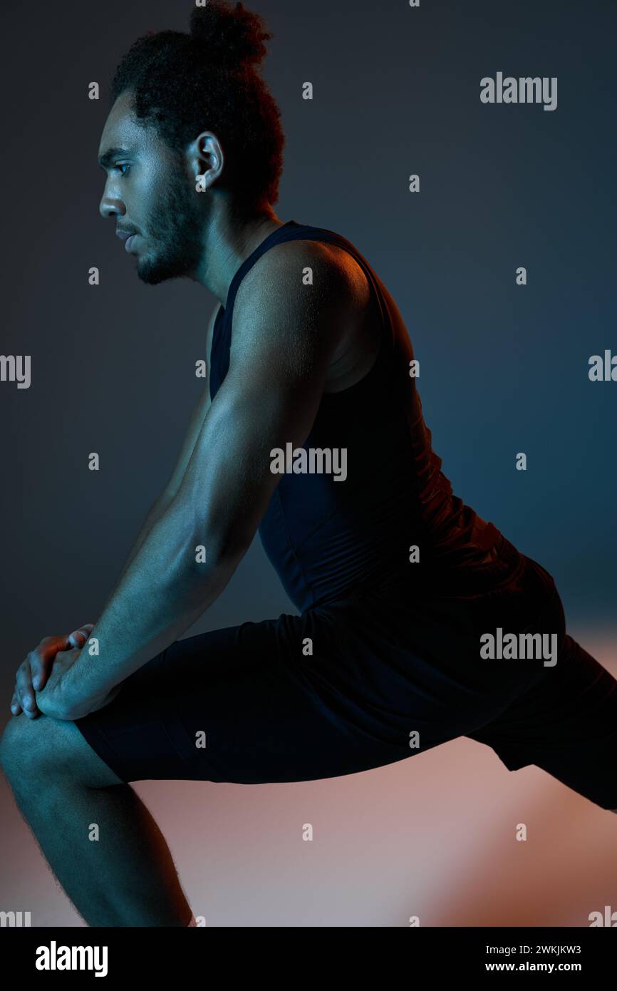 good looking athletic african american man in sportwear stretching ...