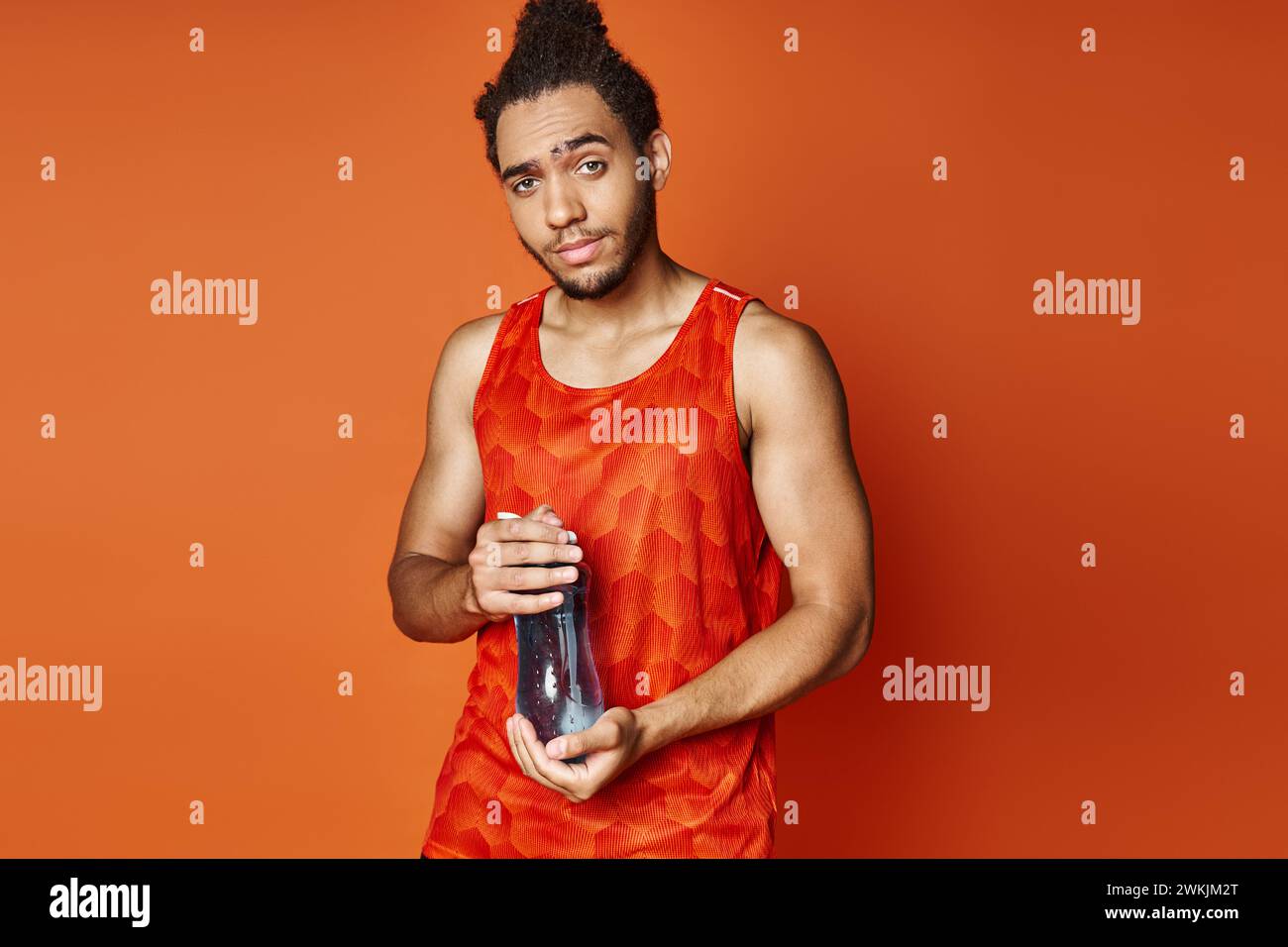 good looking athletic african american man in sportwear with water ...