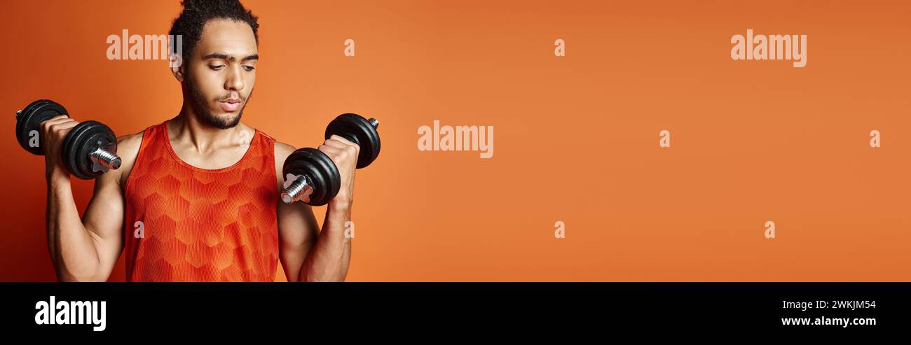 athletic african american man in sport uniform training with dumbbells ...